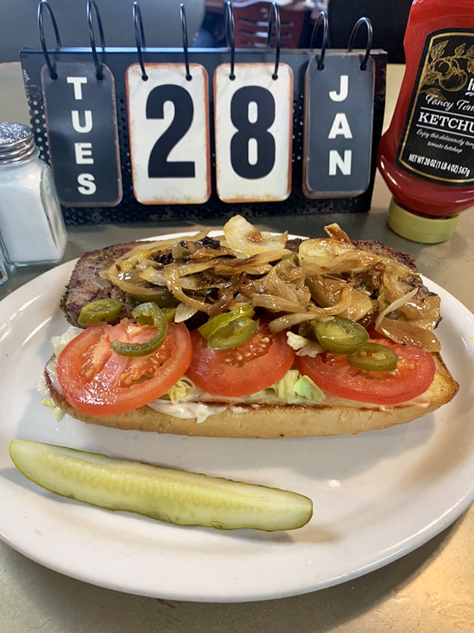 A sandwich that tells a story &ndash; caramelized onions, jalape&ntilde;os, and tomatoes creating the perfect supporting cast for a hearty meatloaf star.