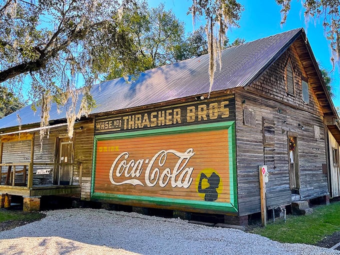 The weathered wooden exterior of Thrasher Bros store stands as a living museum piece, its vintage Coca-Cola sign a portal to simpler times. 