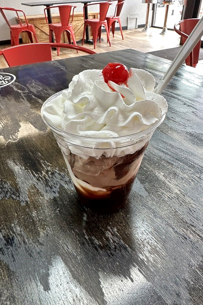 The Mississippi Mud Sundae isn't just a dessert, it's architecture. That whipped cream crown with cherry scepter rules over a kingdom of chocolate bliss.