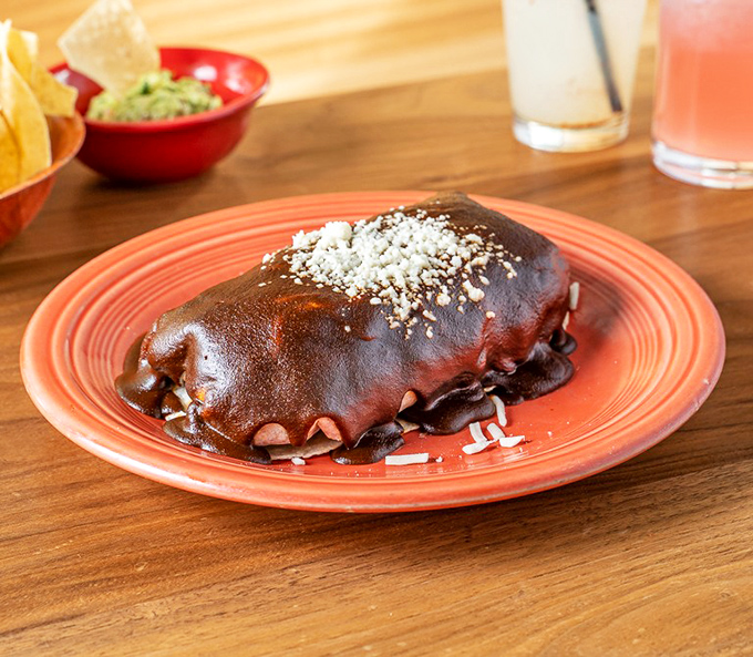 Not all heroes wear capes&mdash;some wear mole sauce. This dark, mysterious poblano-covered burrito is the Batman of Mexican cuisine: rich, complex, and unforgettable.