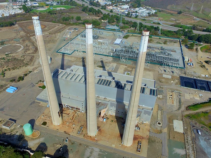 The old power plant's towering stacks stand as industrial sentinels against the coastal landscape, a reminder of California's evolving relationship with energy.