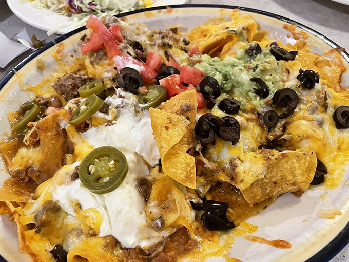 Nachos Supreme that doesn't mess around—every chip is a treasure hunt of seasoned beef, melted cheese, jalapeños, and that perfect dollop of guacamole.