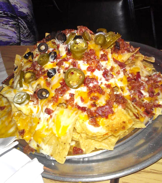 Nachos that require a structural engineer's approval. The jalape&ntilde;os aren't just toppings; they're exclamation points in this cheese-covered story.