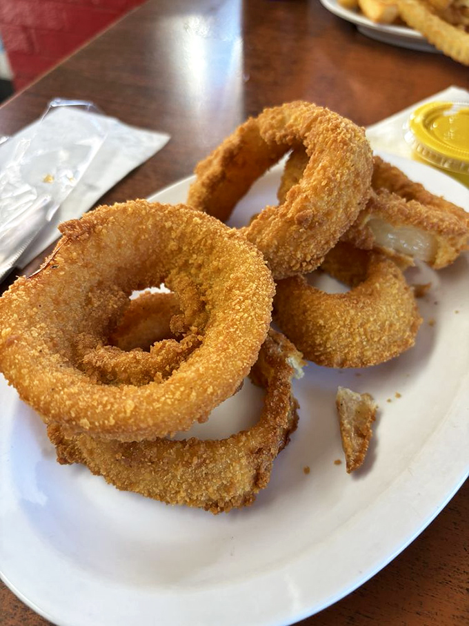 These onion rings aren't just side dishes; they're golden halos of happiness. Perfectly breaded, fried to crispy perfection, and worth every napkin you'll need.