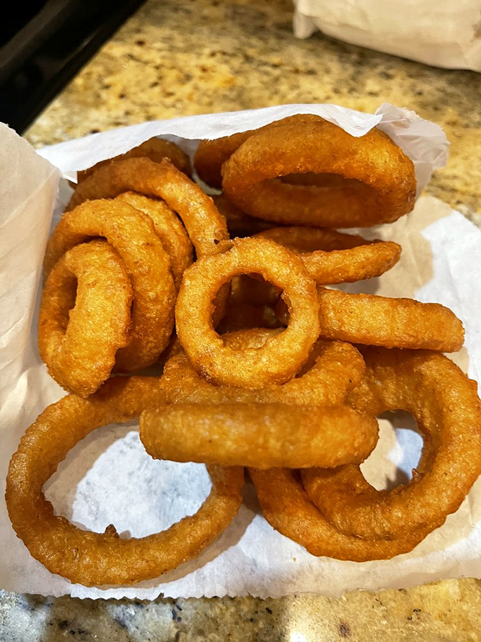 These aren't just onion rings; they're golden halos of crispy perfection that make you wonder why anyone bothers with jewelry.