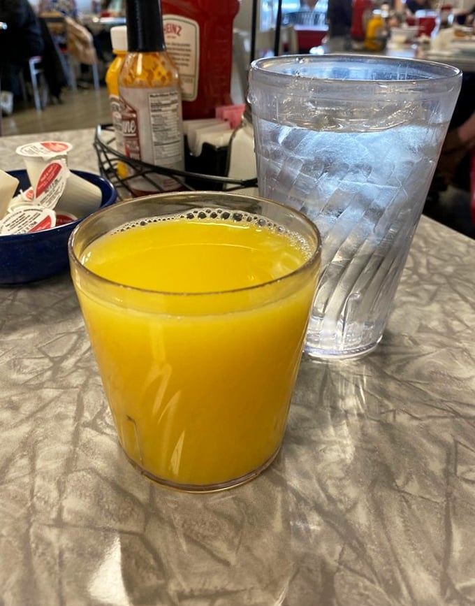 Orange juice so bright it could wake you up before you even take a sip &ndash; nature's alarm clock in a water-beaded glass.