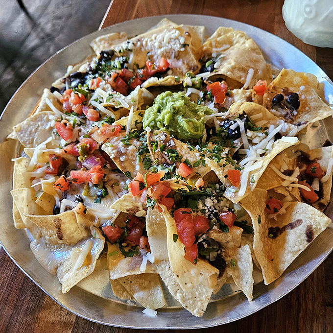 Architecture students take note: this is how you build a proper nacho mountain. Every chip a perfect vehicle for maximum flavor delivery.