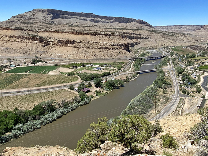 The Colorado River carves its ancient path through Palisade's valley, creating the perfect microclimate for peaches and panoramic hiking views.