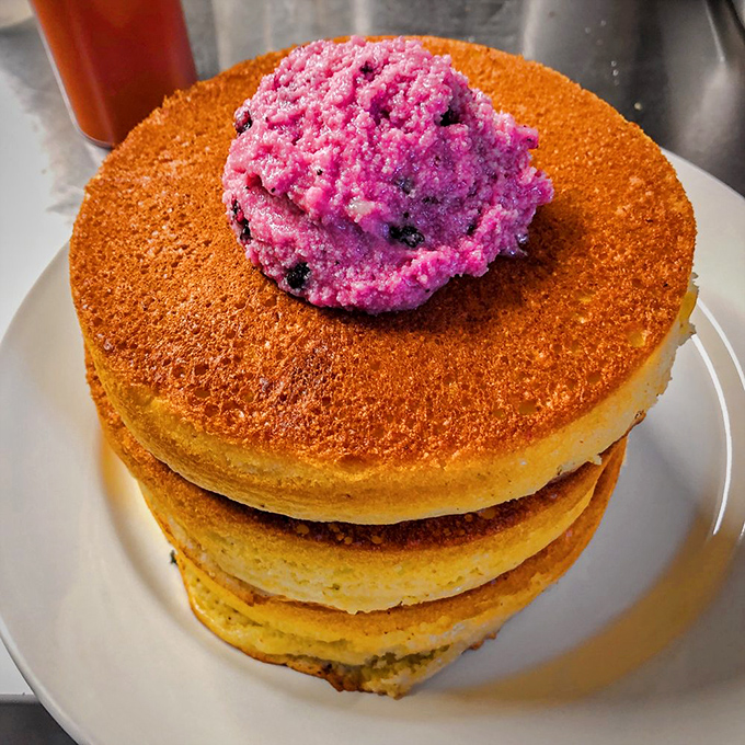 The pancake-to-topping ratio here is mathematical perfection. That vibrant berry topping adds both color and conscience to your indulgence.