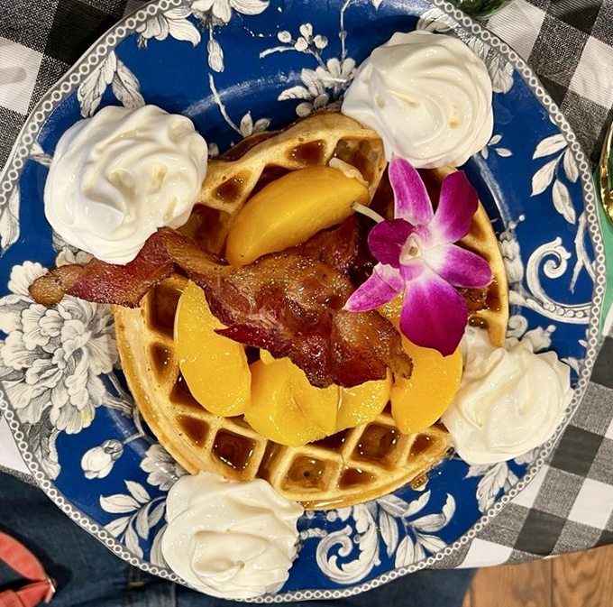 Whoever thought to pair peaches, bacon, and waffles deserves a Nobel Prize in breakfast innovation&mdash;the whipped cream is just showing off.