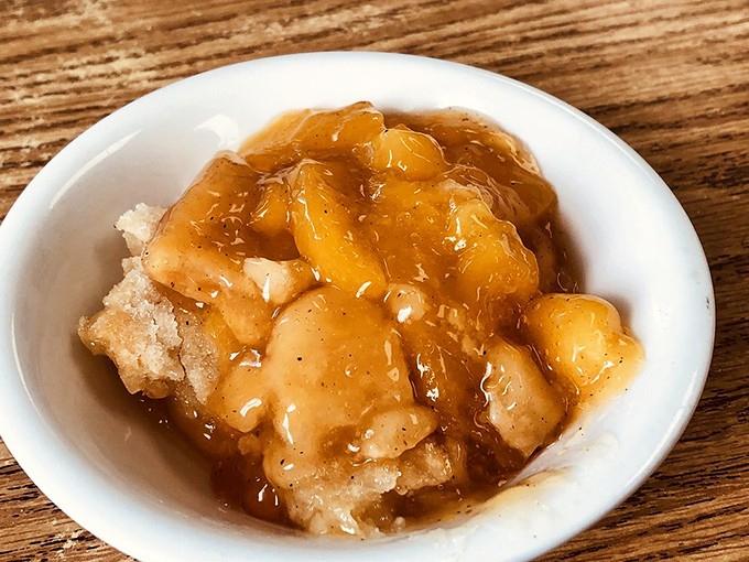 This isn't just peach cobbler&mdash;it's summer in Mississippi captured in a bowl, warm fruit swimming in syrup that demands to be savored.