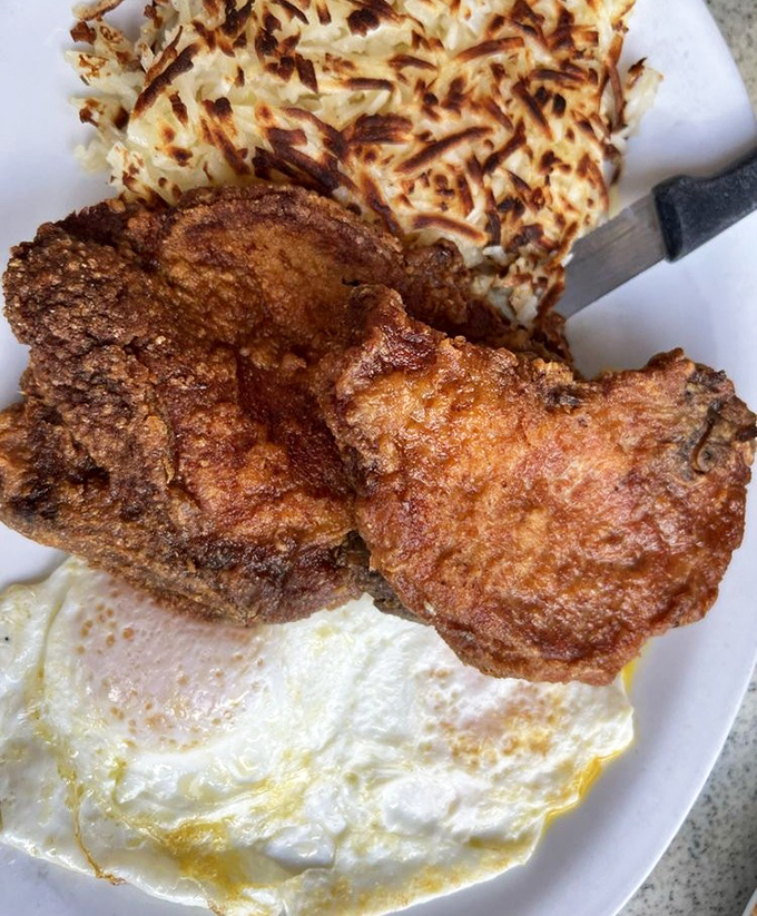 These golden-brown pork chops with hash browns and eggs could cure any ailment known to humanity. Doctors should prescribe this plate.
