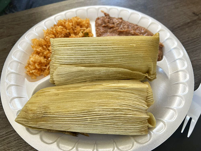 These tamales aren't just wrapped in corn husks&mdash;they're wrapped in tradition, served with rice and beans for the full experience.