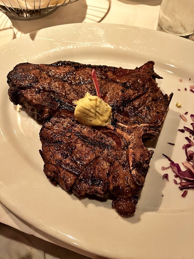 A porterhouse with perfect char marks that whispers, "I've been waiting for you all my life," topped with a dollop of butter for good measure.