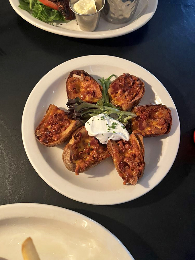 Potato skins arranged like a flower, with melted cheese and toppings that make you wonder why we ever stopped ordering these beauties.