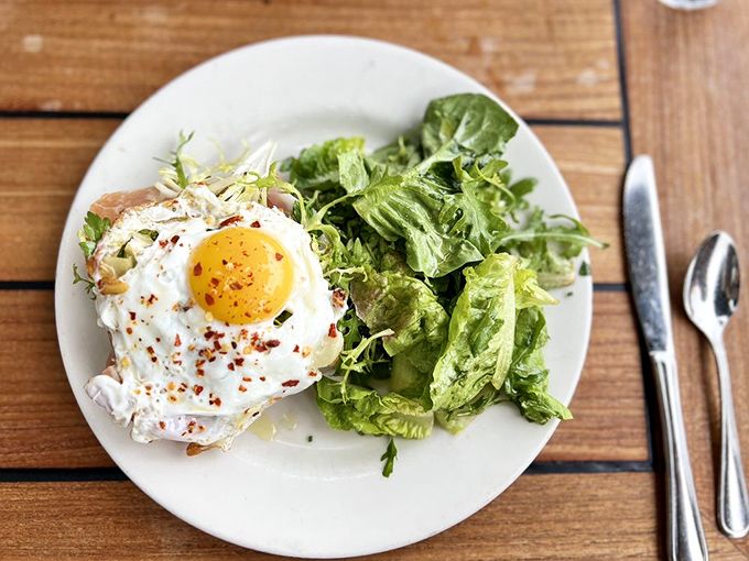 A simple green salad alongside a perfectly cooked egg&mdash;proof that breakfast doesn't always need to be a guilt trip.