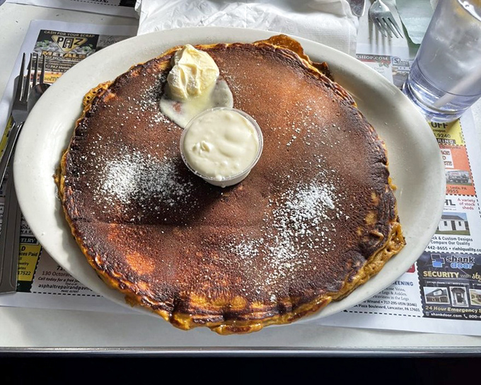 A pancake so perfect it deserves its own ZIP code. That melting butter pat is just showing off at this point.