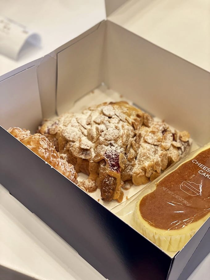 This almond croissant isn't just breakfast – it's edible architecture, with delicate layers supporting a dusting of powdered sugar like fresh snow on a pastry mountain.