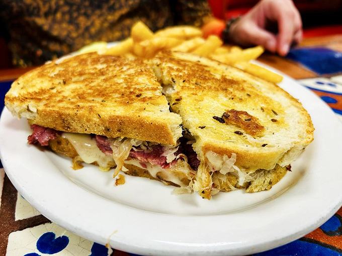 The Reuben sandwich – where sauerkraut, corned beef, and melted cheese create the holy trinity of lunchtime satisfaction.