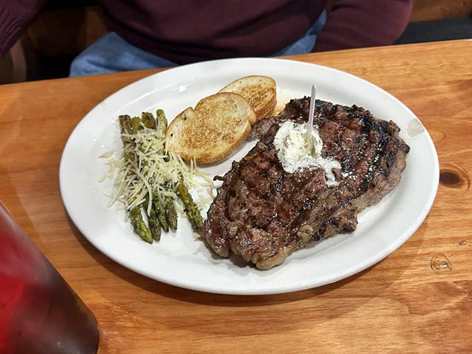 A ribeye so perfectly cooked it deserves its own Instagram account, complemented by grilled asparagus and Texas toast for good measure.