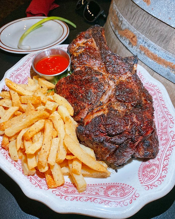 This isn't just dinner&mdash;it's a primal experience with a side of fries. The char marks tell stories of flame-kissed perfection.