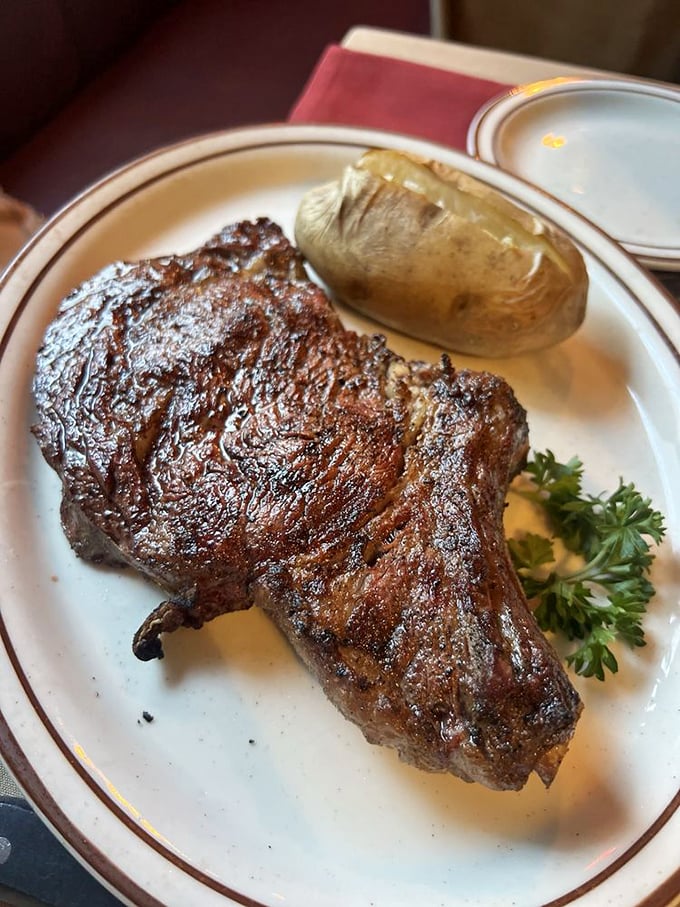 A steak so perfectly seared it could make a vegetarian question their life choices. That baked potato stands by like a faithful sidekick.