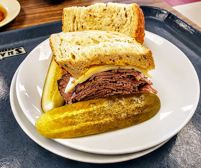This isn't just a roast beef sandwich; it's a masterclass in meat architecture with that pickle providing structural support.