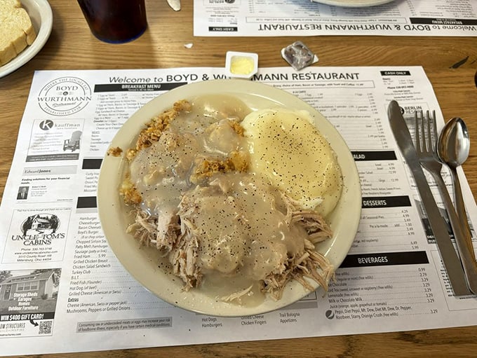 Mashed potatoes swimming in gravy next to a slice of meatloaf that's clearly been taking its comfort food responsibilities seriously.