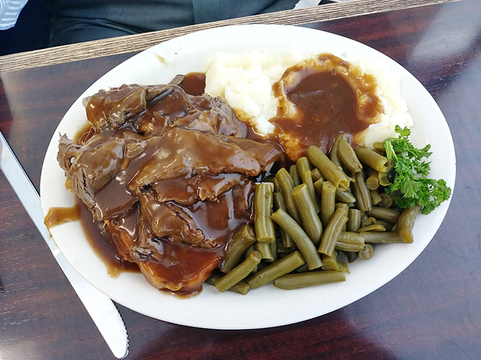 When comfort food gets dressed up for dinner&mdash;tender meat swimming in gravy with sides that know their supporting role. This isn't a meal, it's a hug on a plate.