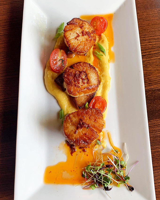 These perfectly seared scallops nestled on creamy puree are the ocean's answer to comfort food. The caramelization on those beauties would make a pastry chef jealous.