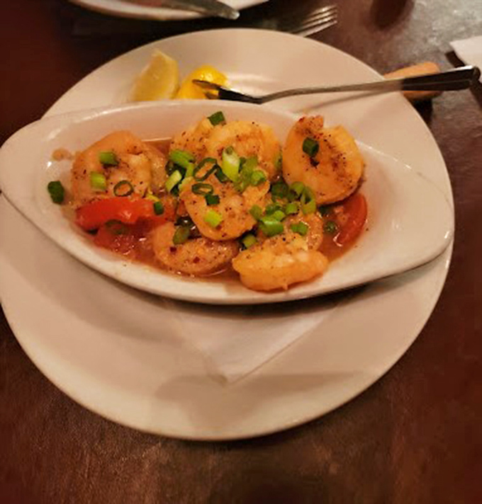 Plump shrimp swimming in a garlicky sauce with bright scallions&mdash;seafood that tastes like it just had a spa day in butter.