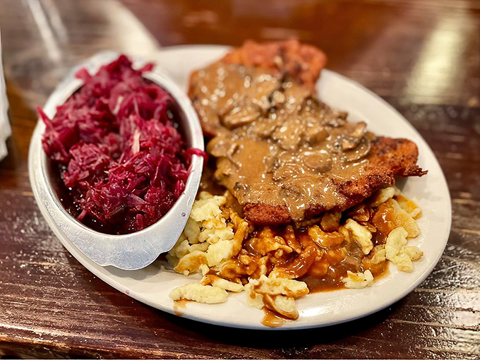 Behold the j&auml;ger schnitzel in its natural habitat&mdash;swimming in mushroom gravy alongside red cabbage, a combination that could make a grown German weep with joy.