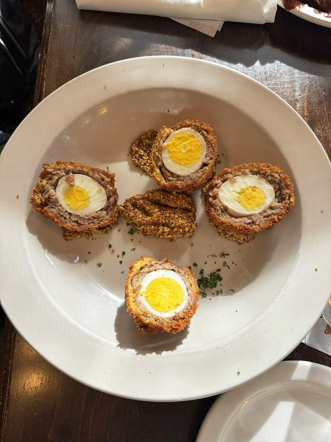 Scotch eggs&mdash;where breakfast meets engineering. Hard-boiled eggs wrapped in sausage, breaded, and fried into little orbs of protein perfection.