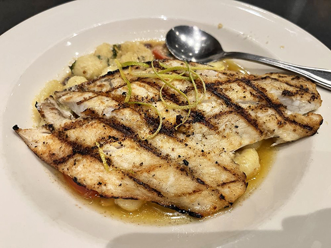 Perfectly grilled fish resting in a delicate sauce&mdash;proof that simplicity, when executed with precision, creates the most memorable meals.