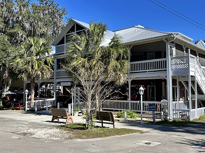 Under the watchful gaze of ancient oaks, this white house with its welcoming porch practically begs you to sit a spell. 