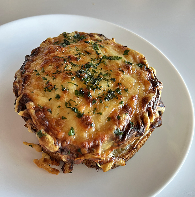 A shepherd's pie that appears to have been kissed by the gods of cheese. The herbs sprinkled on top aren't garnish&mdash;they're a crown.