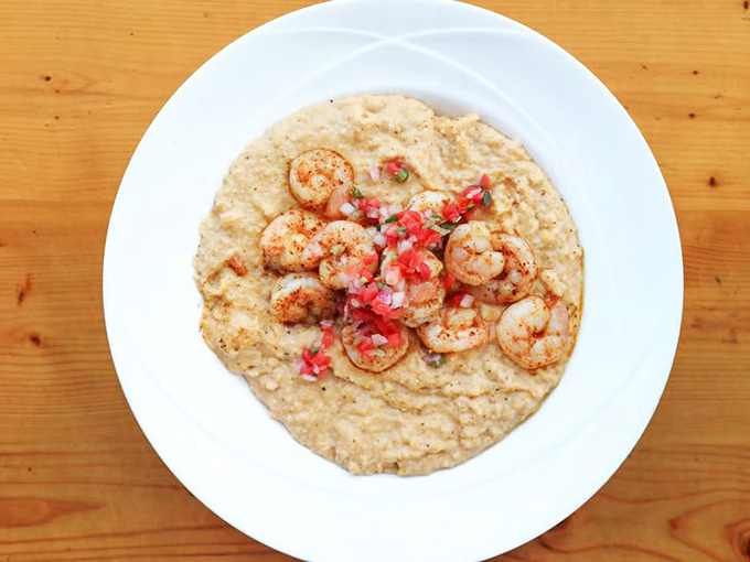 Creamy grits crowned with plump, seasoned shrimp and fresh pico de gallo&mdash;Southern comfort with a chef's touch.