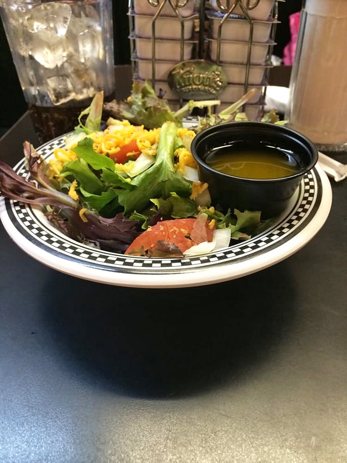 Even the side salad gets special treatment here. Fresh greens, tomatoes, and cheese with dressing on the side &ndash; because sometimes you need something green before pie shake indulgence.