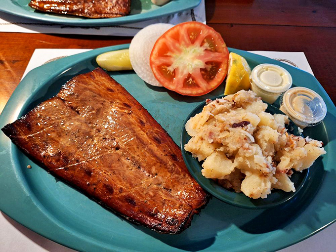 The mahi-mahi arrives like a smoky postcard from paradise, accompanied by German potato salad that could make a Bavarian grandmother nod in approval.