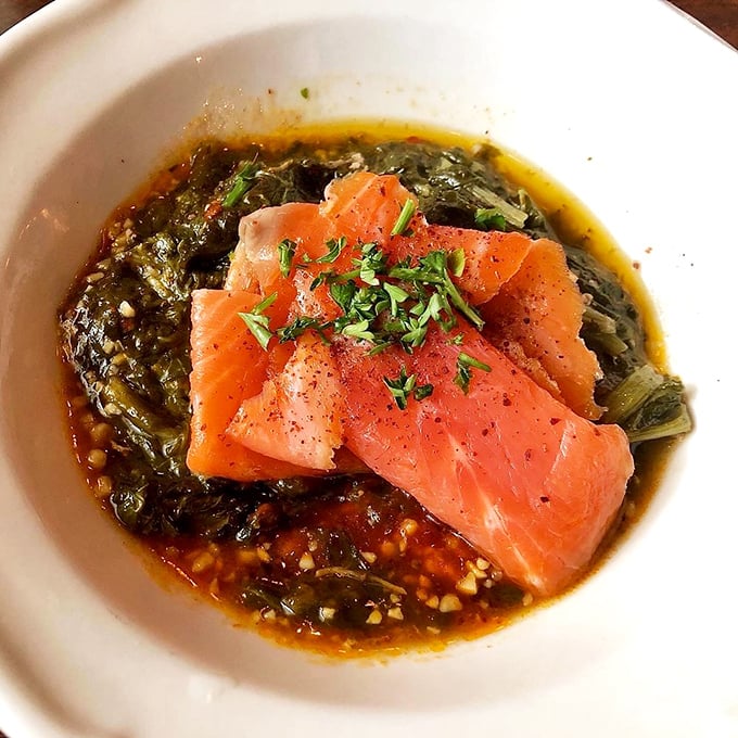 Delicate smoked trout resting on a bed of savory greens in aromatic broth. Proof that Indiana and sophisticated seafood aren't mutually exclusive concepts.