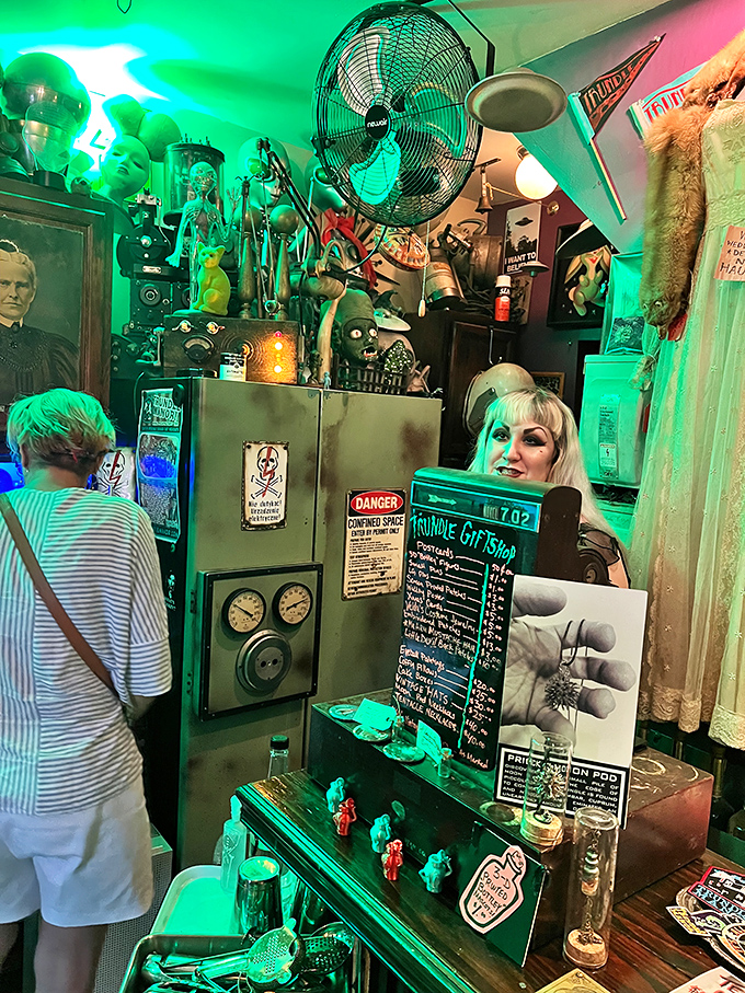 Gift shop or portal to another dimension? The neon-bathed curiosity counter offers keepsakes for those brave enough to bring a piece of the manor home.