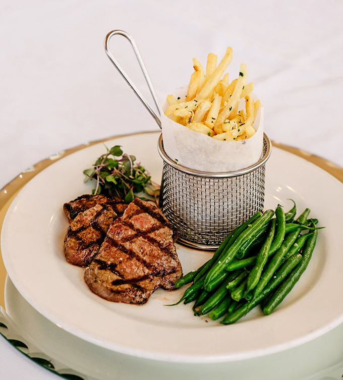 Steak frites: where a perfectly grilled piece of beef meets its soulmate—a basket of crispy, herb-flecked fries standing at attention.