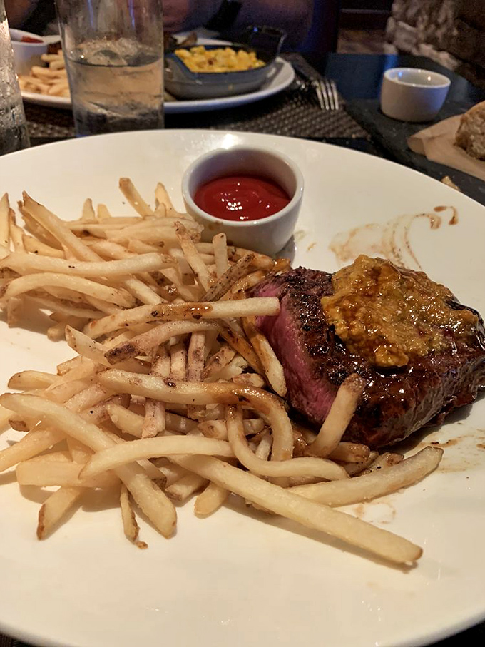 Medium-rare perfection meets crispy frites in a combination that would make French bistros nod with approval and slight envy.