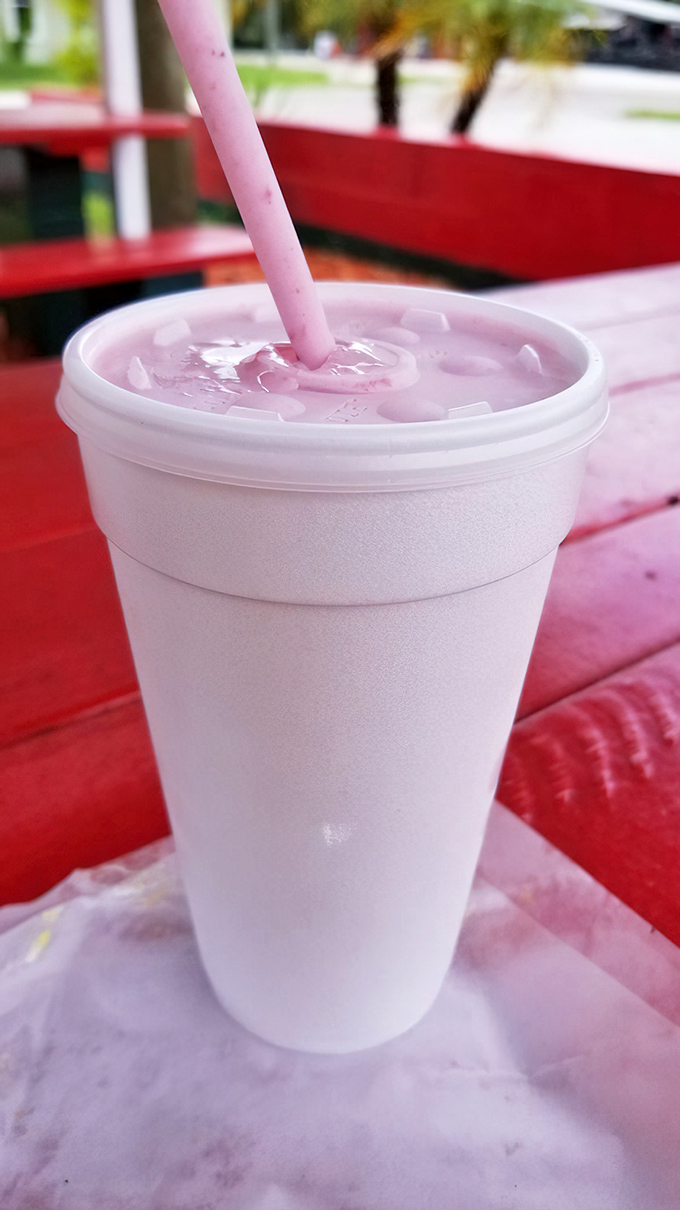 This strawberry milkshake isn't just pink&mdash;it's a commitment to berry excellence. The straw stands at attention, ready for sipping duty.