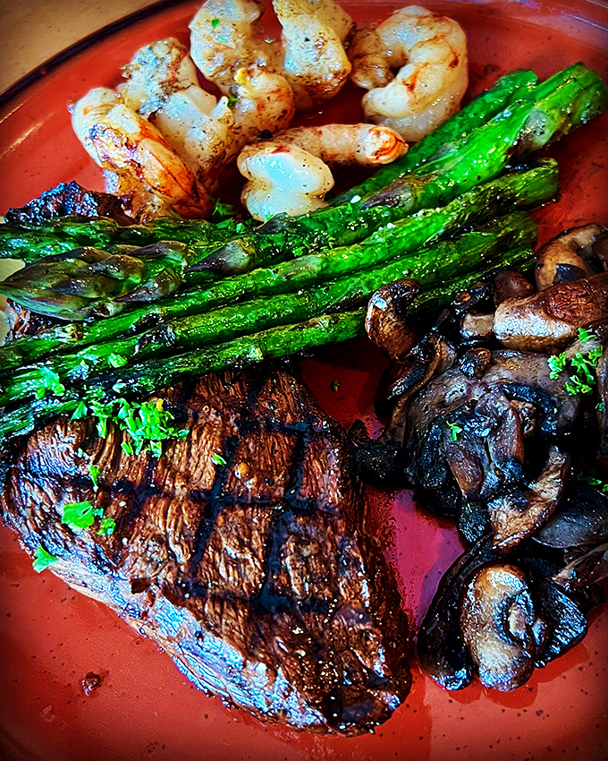 The land-meets-sea romance we all need: tender steak, plump shrimp, and grilled asparagus on a plate that's basically edible poetry.