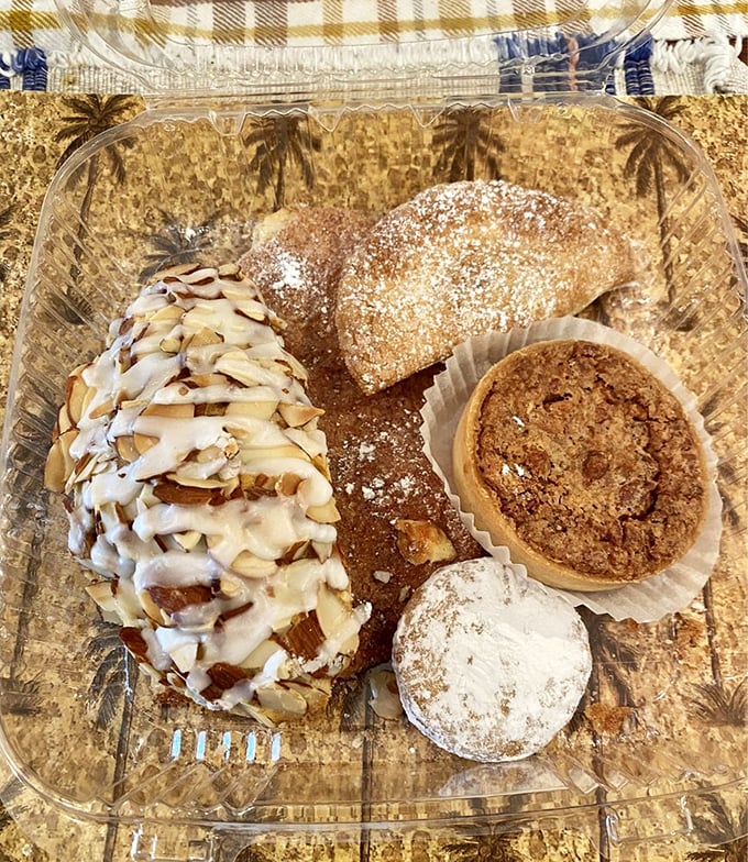 A pastry sampler that belongs in an art gallery. That almond-topped creation is practically begging to be eaten first.