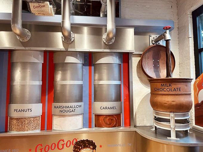 That cross-section reveals the architectural wonder of a Goo Goo Cluster &ndash; layers of caramel, nougat, and nuts embraced by chocolate like a sweet group hug.