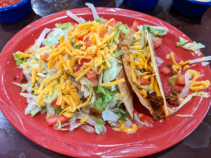 These tacos aren't playing around. Stuffed with generous fillings and topped with fresh lettuce, tomato, and cheese, they're served on a plate as vibrant as their flavors.