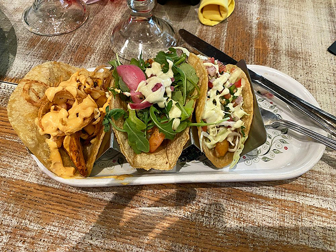 Tacos presented with the care of a jewelry display. That crispy garnish is the culinary equivalent of a perfect accessory.