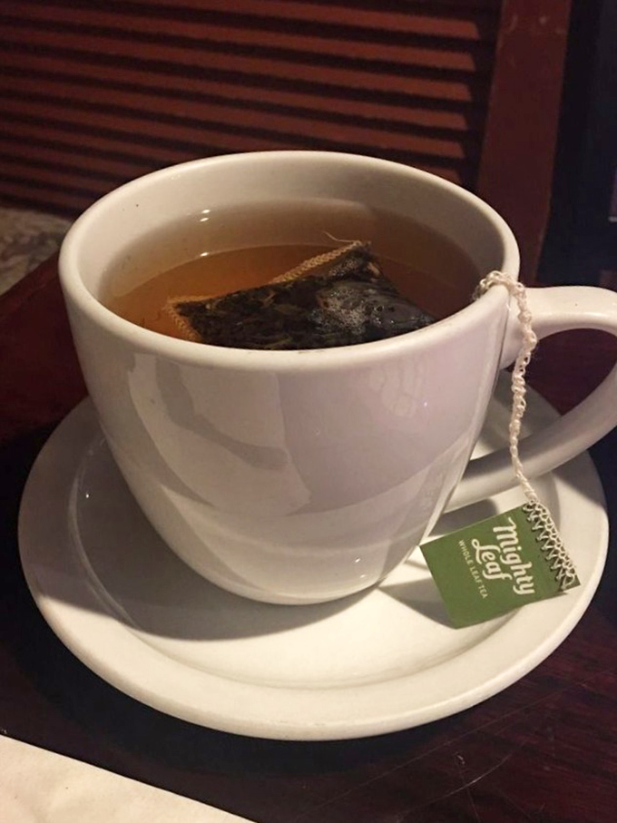 A proper cup of tea, complete with string dangling over the edge&mdash;civilization's most civilized pause button in ceramic form.